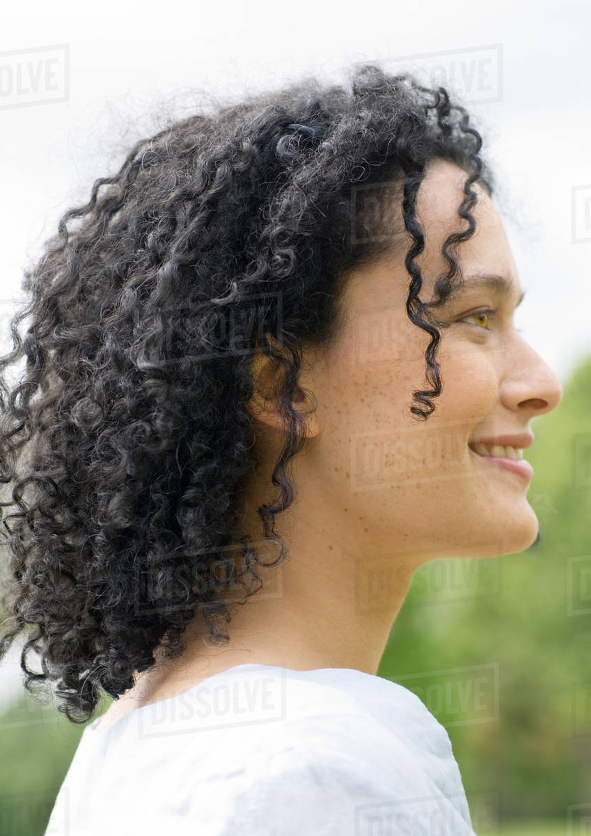 Young woman smiling, side view, portrait - Royalty-free Stock Photo ...
