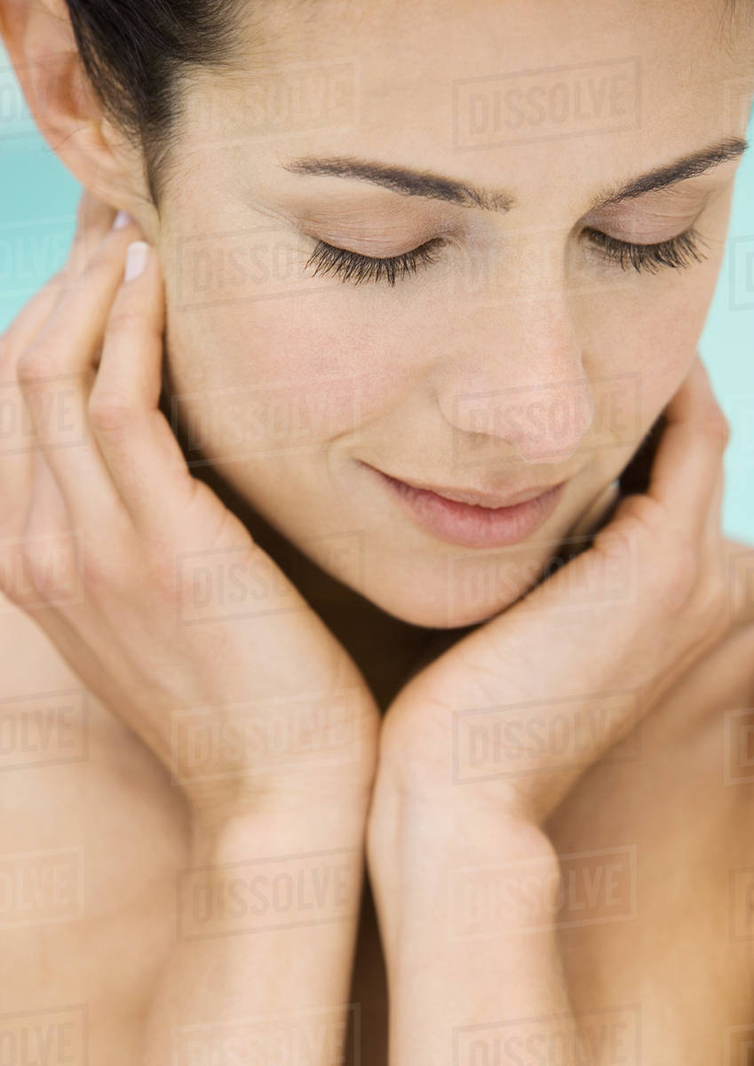 Woman with hands under face, close-up - Royalty-free Stock Photo | Dissolve