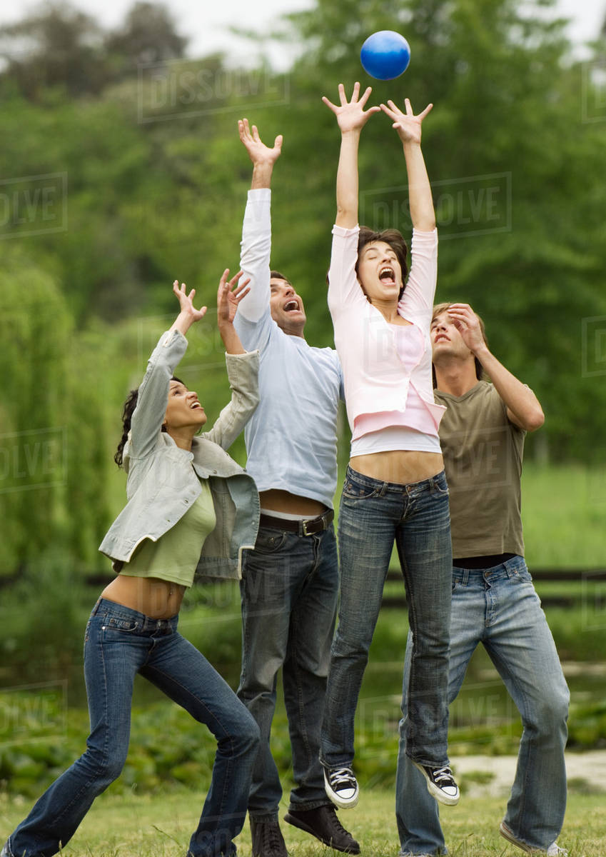 Young people jumping for ball - Royalty-free Stock Photo | Dissolve