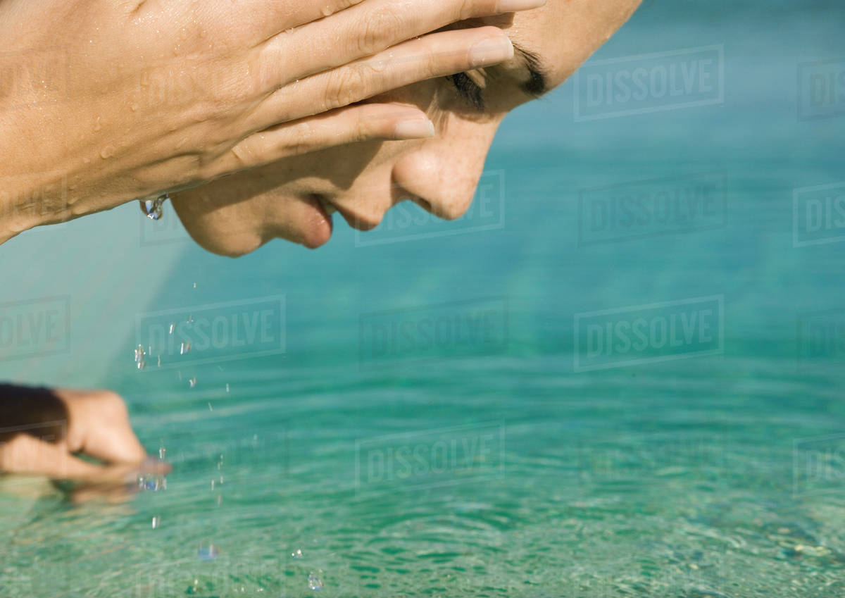 Woman splashing face with water - Royalty-free Stock Photo | Dissolve