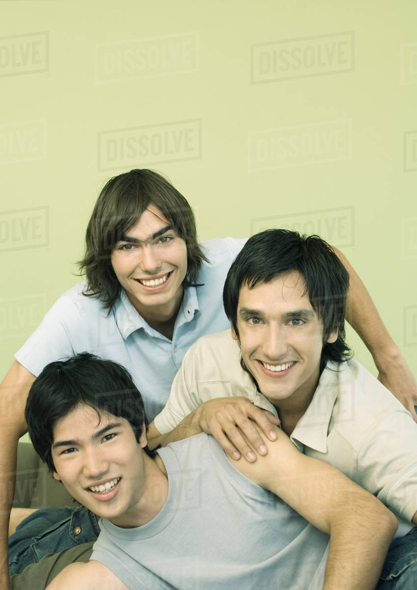 Three young male friends smiling, portrait - Stock Photo - Dissolve