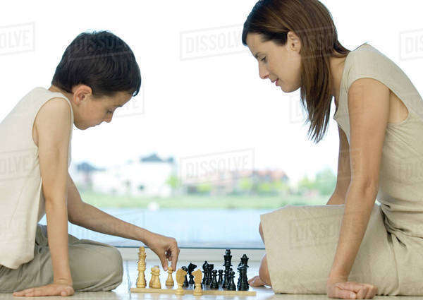 Mother and son playing chess - Royalty-free Stock Photo | Dissolve