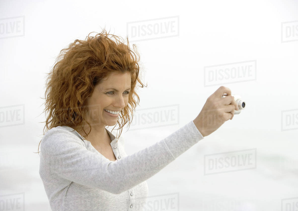 Woman using digital camera - Royalty-free Stock Photo | Dissolve