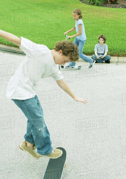 Suburban children playing in street - Royalty-free Stock Photo | Dissolve