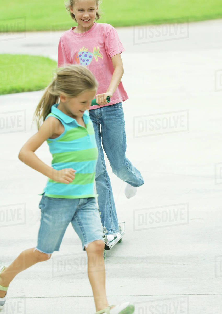 Suburban children playing in driveway - Royalty-free Stock Photo | Dissolve