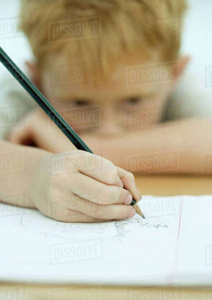 Boy drawing in notebook - Royalty-free Stock Photo | Dissolve