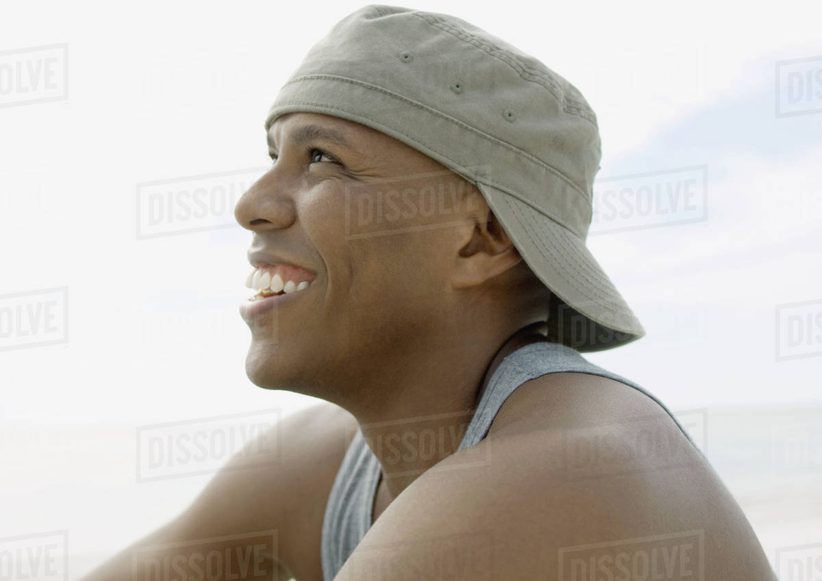 Man wearing cap backwards, laughing - Royalty-free Stock Photo | Dissolve