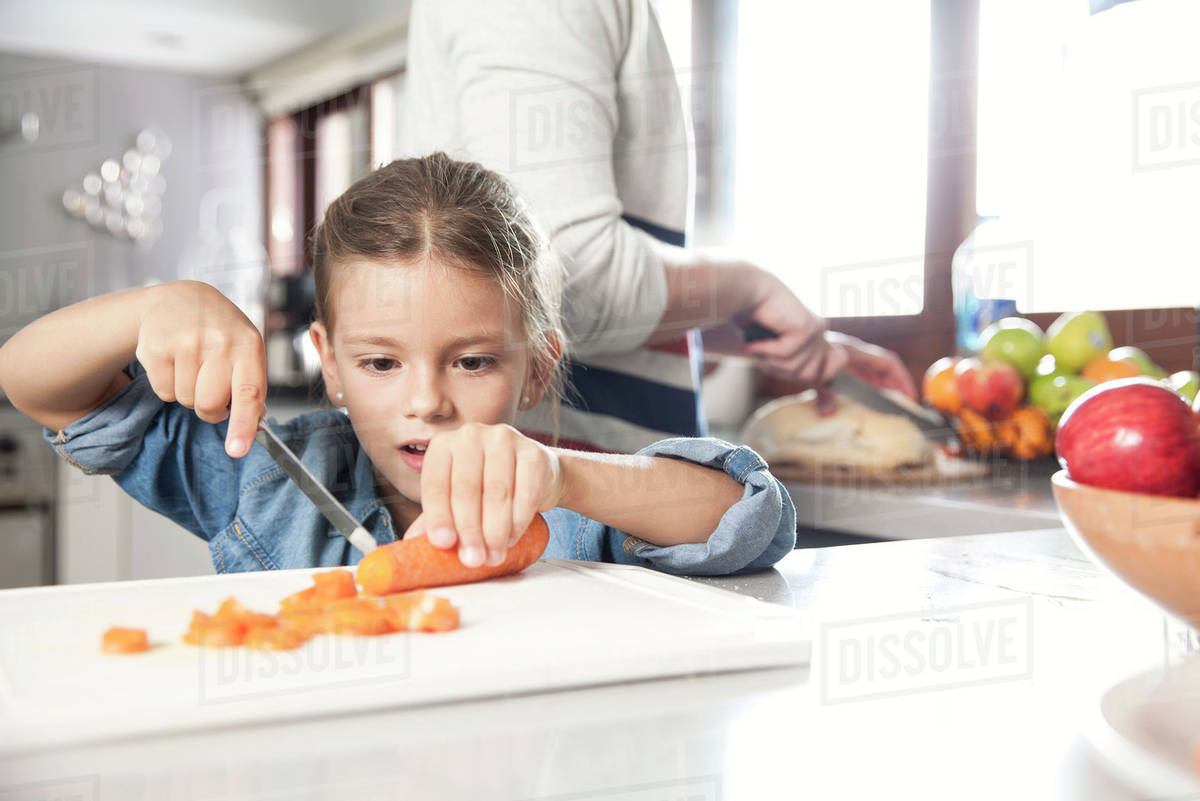 Little girl helping to prepare food in kitchen - Royalty-free Stock ...