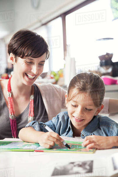 Mother teaching young daughter to read - Royalty-free Stock Photo ...