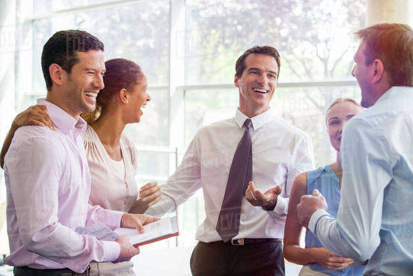 Colleagues having laugh together in office - Royalty-free Stock Photo ...