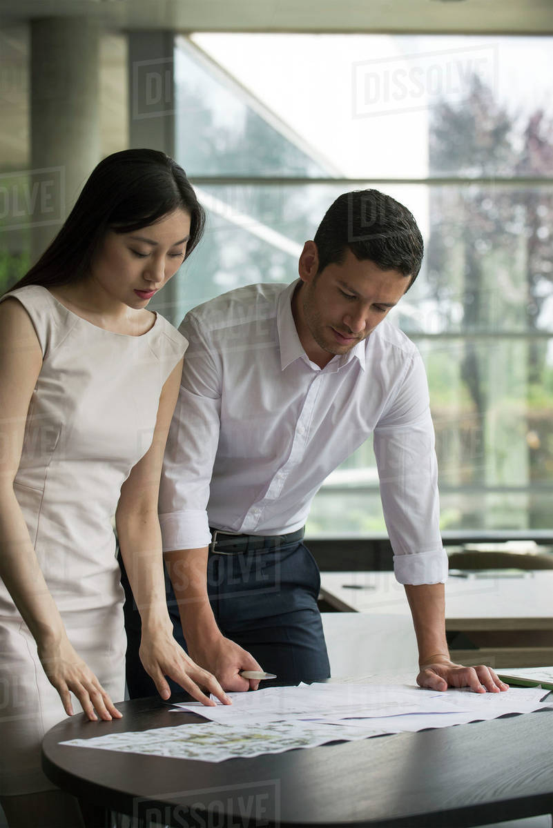 Engineer and associate working closely together on project - Royalty ...