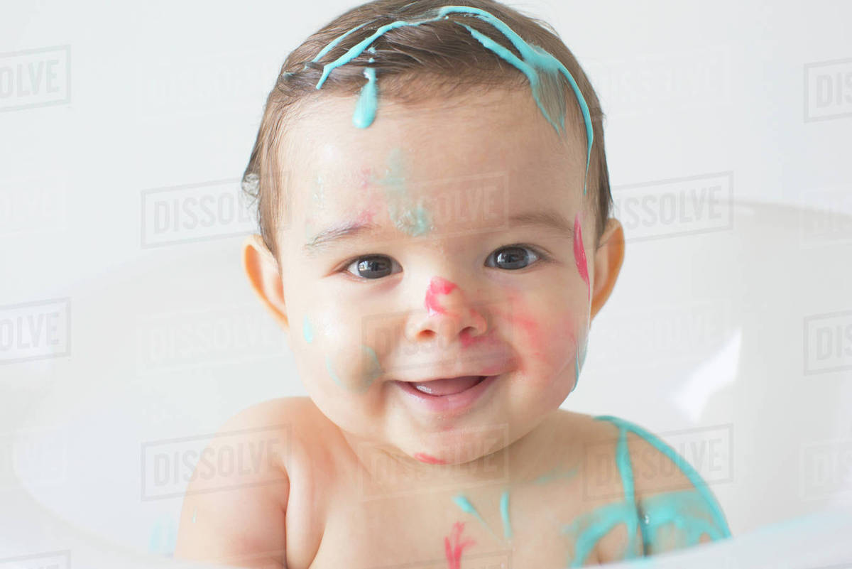 Baby splattered in colorful soap at bathtime - Stock Photo - Dissolve