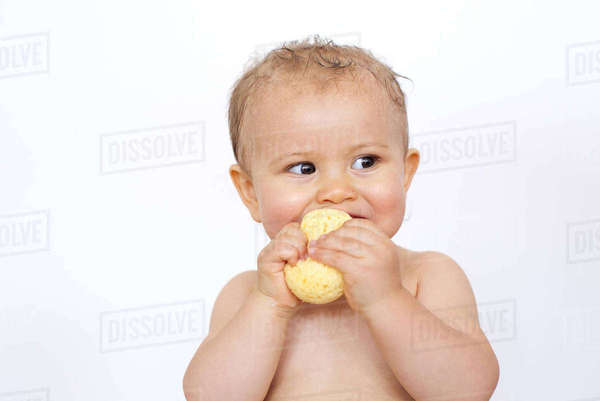 Baby chewing on sponge - Stock Photo - Dissolve