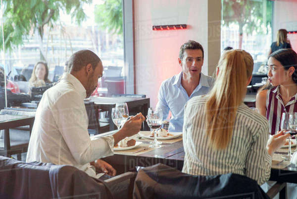 Business associates having lunch together in restaurant - Royalty-free ...