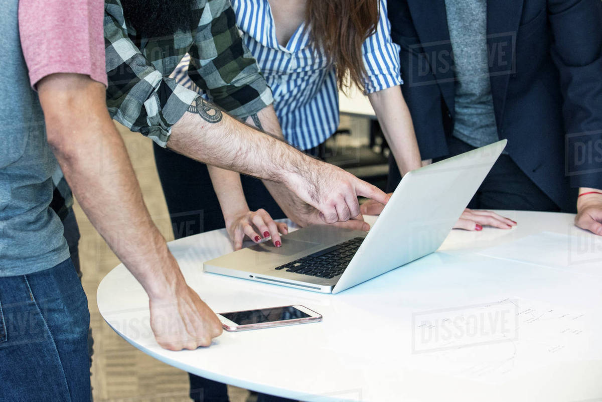 Colleagues working together on laptop computer - Royalty-free Stock ...