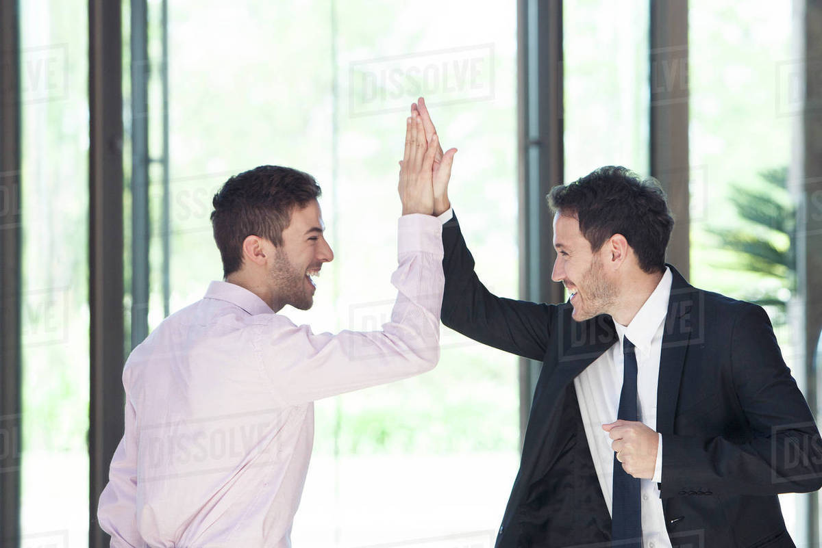 Businessmen congratulating each other with high-five - Stock Photo ...
