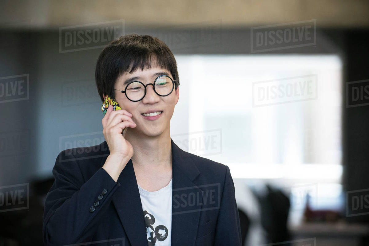 Man using cell phone, smiling cheerfully - Stock Photo - Dissolve