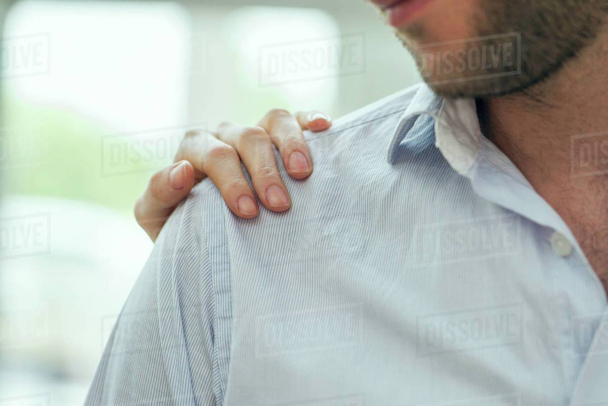 Healthcare worker's hand on patient's shoulder - Royalty-free Stock ...