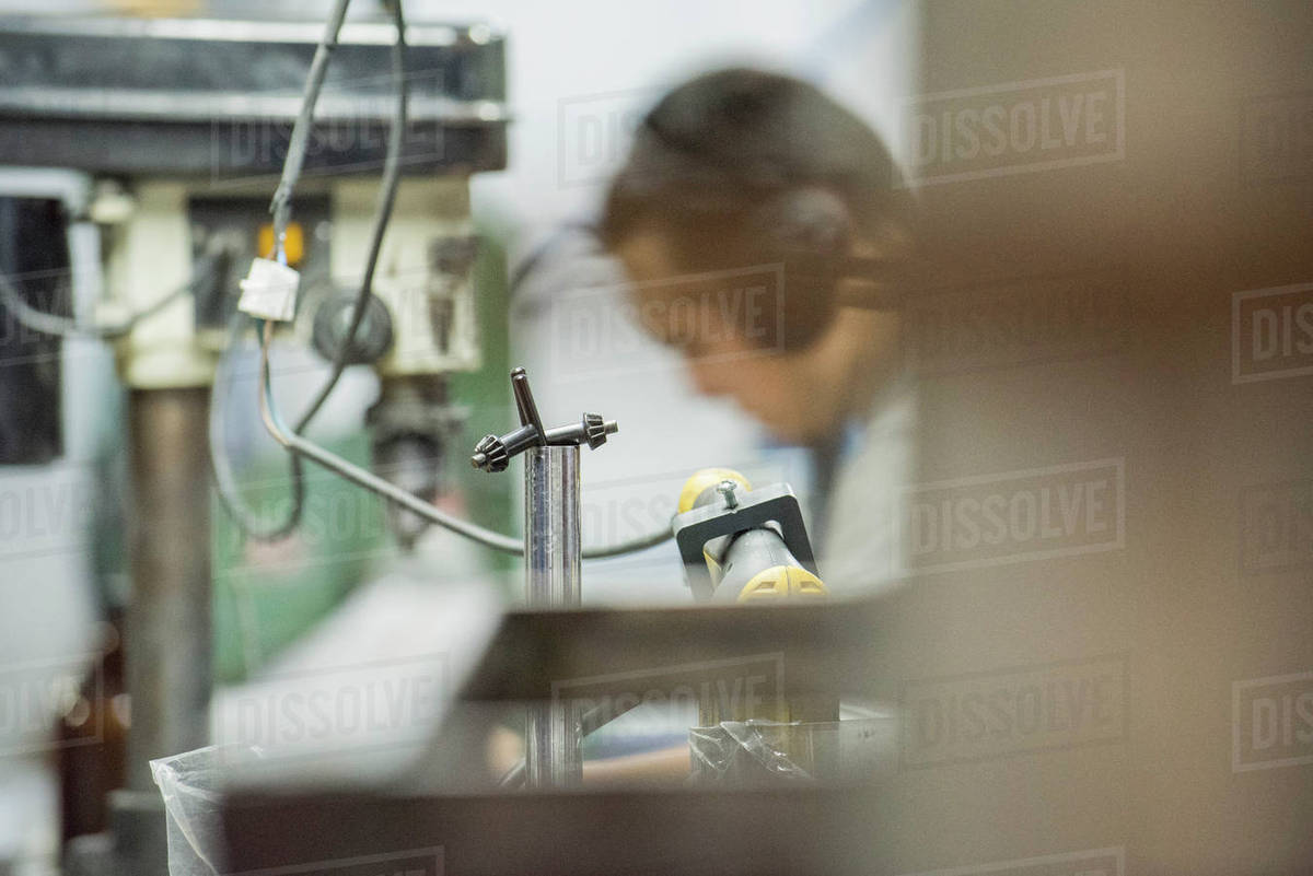 Machinist at work in factory - Stock Photo - Dissolve