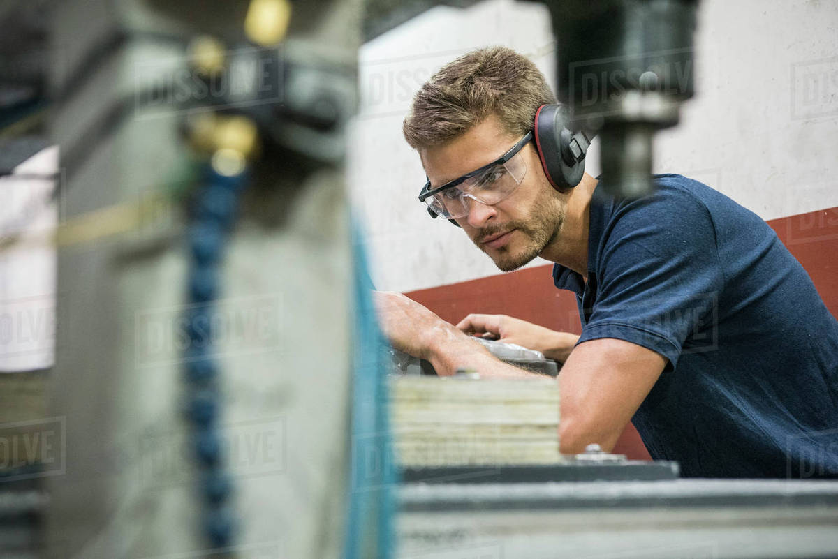 Machinist working in factory - Royalty-free Stock Photo | Dissolve