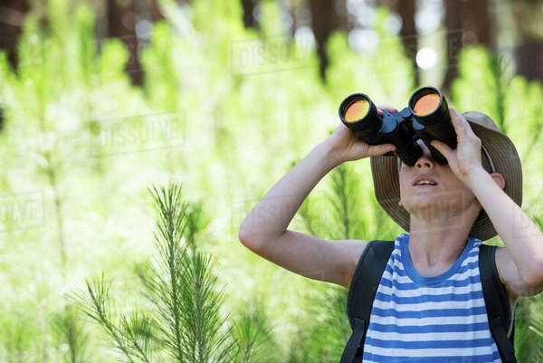 Boy looking through binoculars - Royalty-free Stock Photo | Dissolve