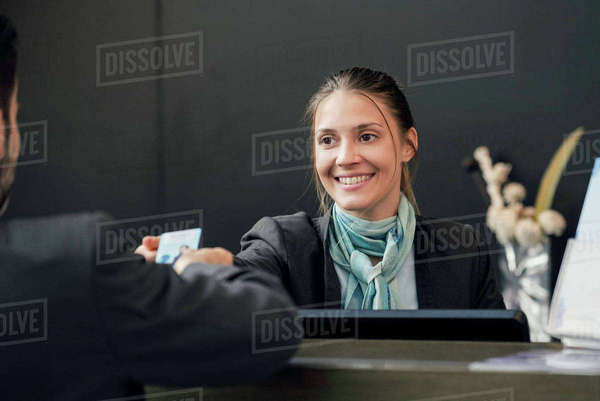 Hotel receptionist helping customer - Royalty-free Stock Photo | Dissolve