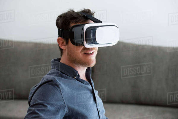 Mid adult man using virtual reality headset - Royalty-free Stock Photo ...