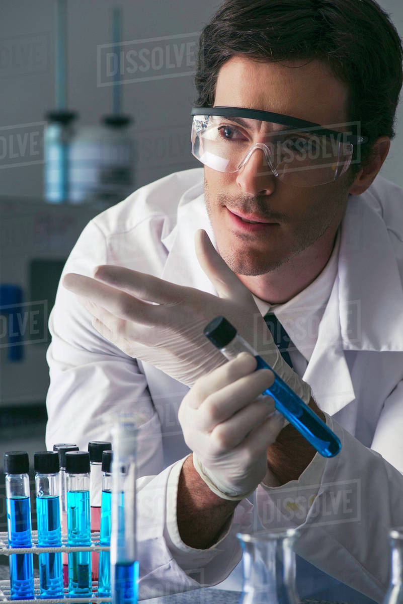 Scientist conducting experiment in lab - Stock Photo - Dissolve