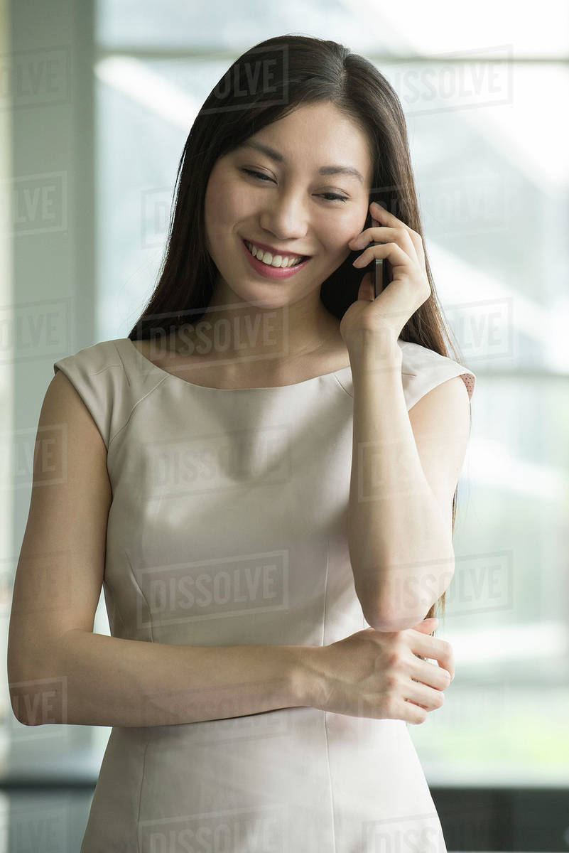 Businesswoman using cell phone - Royalty-free Stock Photo | Dissolve