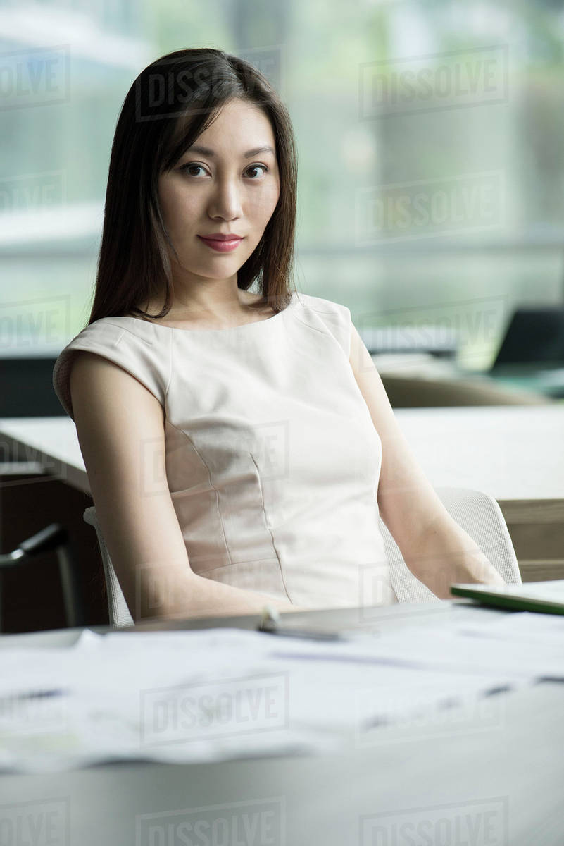 Woman at desk, portrait - Royalty-free Stock Photo | Dissolve