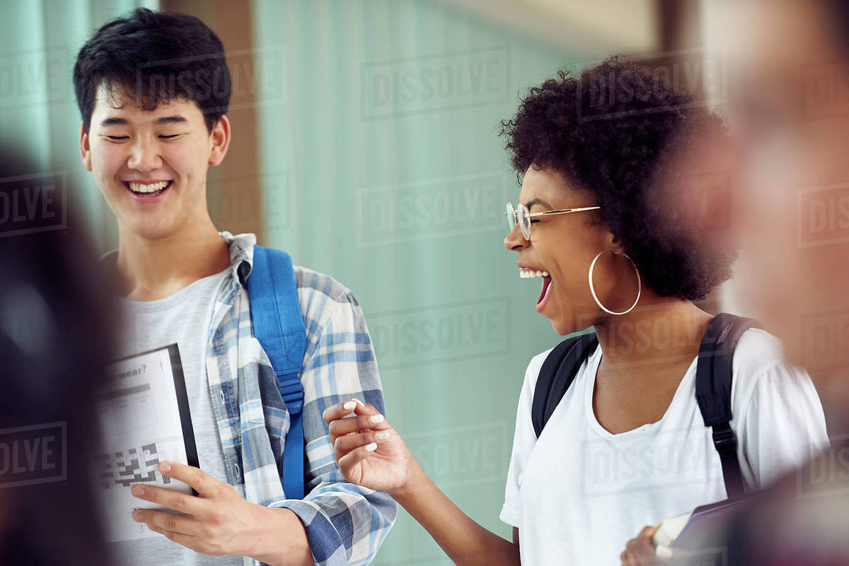 Students laughing together in corridor - Royalty-free Stock Photo ...