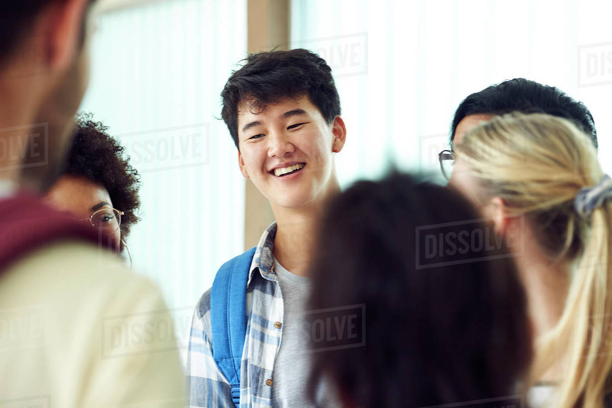 Classmates talking together in corridor - Royalty-free Stock Photo ...
