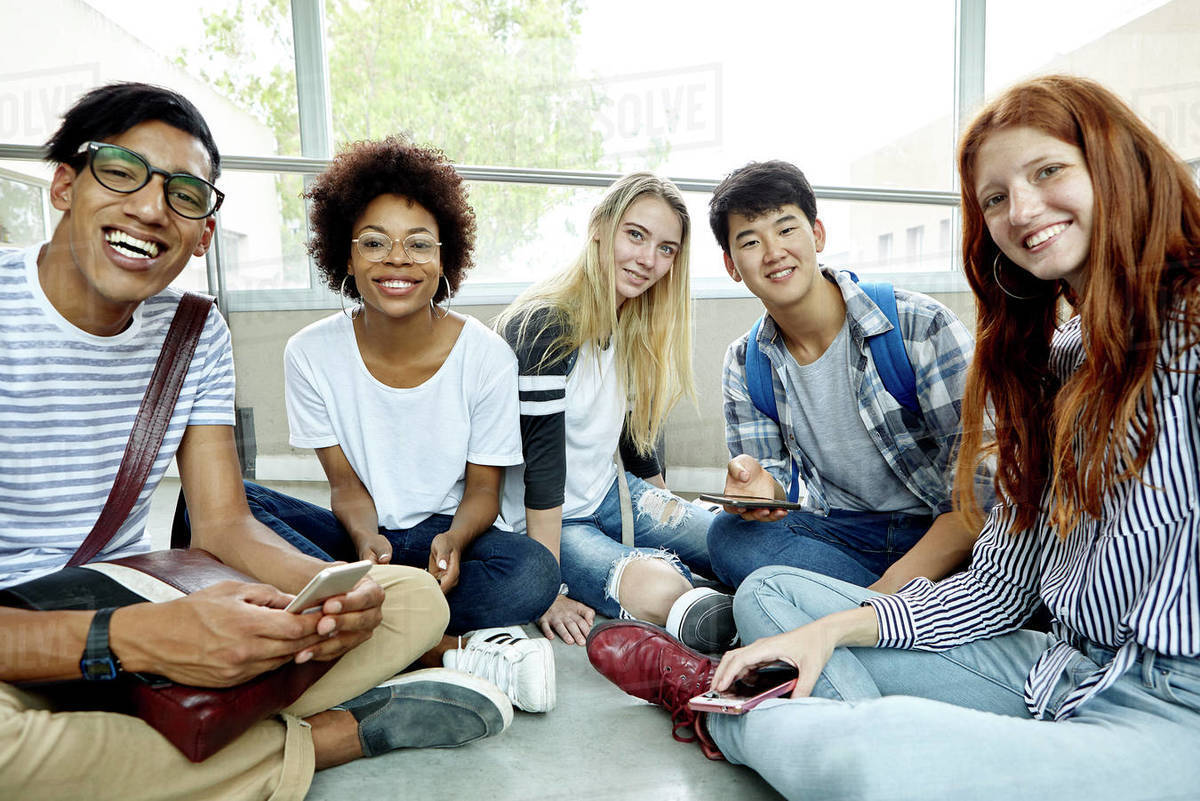 Classmates hanging out together, portrait - Stock Photo - Dissolve