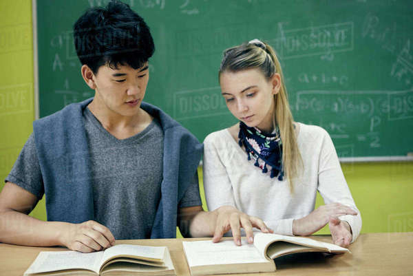 Students working together in math class - Stock Photo - Dissolve