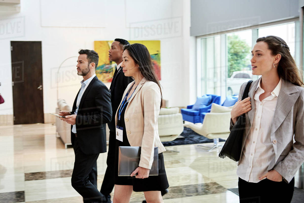 Business people walking in hotel lobby - Royalty-free Stock Photo ...