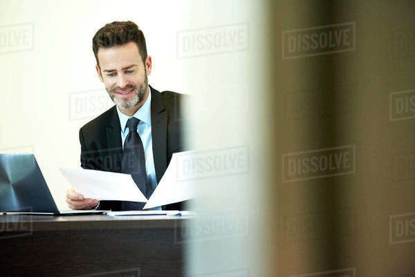 Businessman reading documents in office - Royalty-free Stock Photo ...