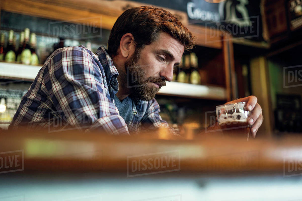 Sad man sitting in beer bar - Royalty-free Stock Photo | Dissolve