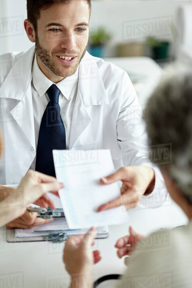Doctor giving prescription to patient - Royalty-free Stock Photo | Dissolve