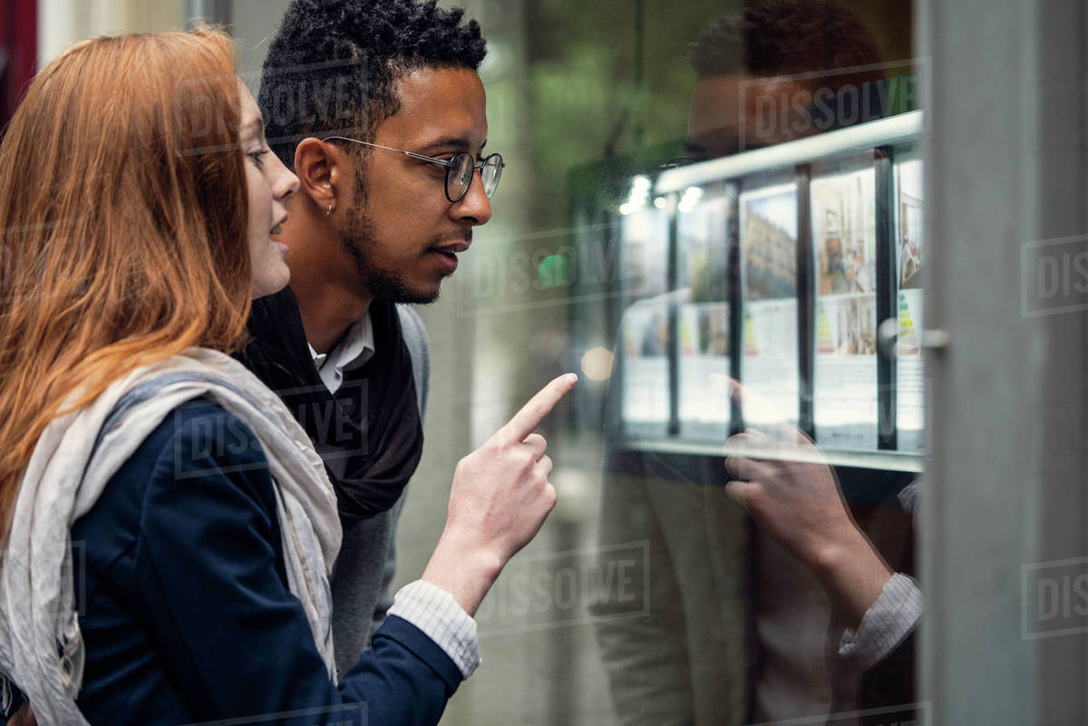 Couple looking at window display - Stock Photo - Dissolve
