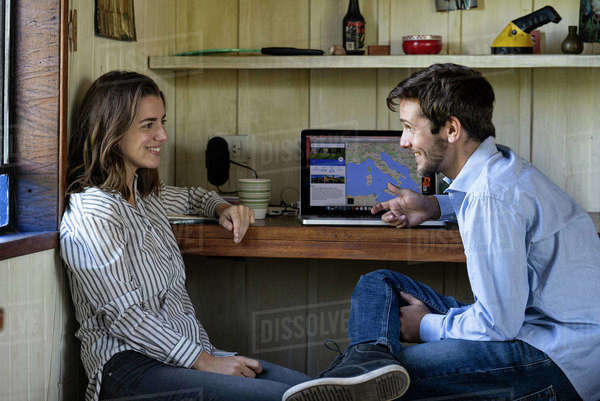 Couple talking with each other in living room - Stock Photo - Dissolve