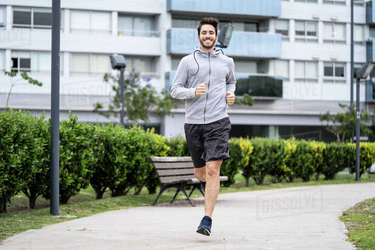Young man jogging in park - Stock Photo - Dissolve