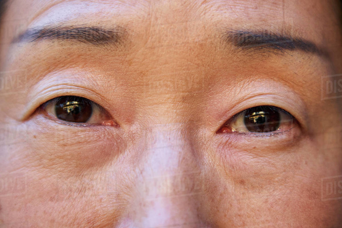 Close up of senior Asian woman's eyes looking at the camera - Royalty ...