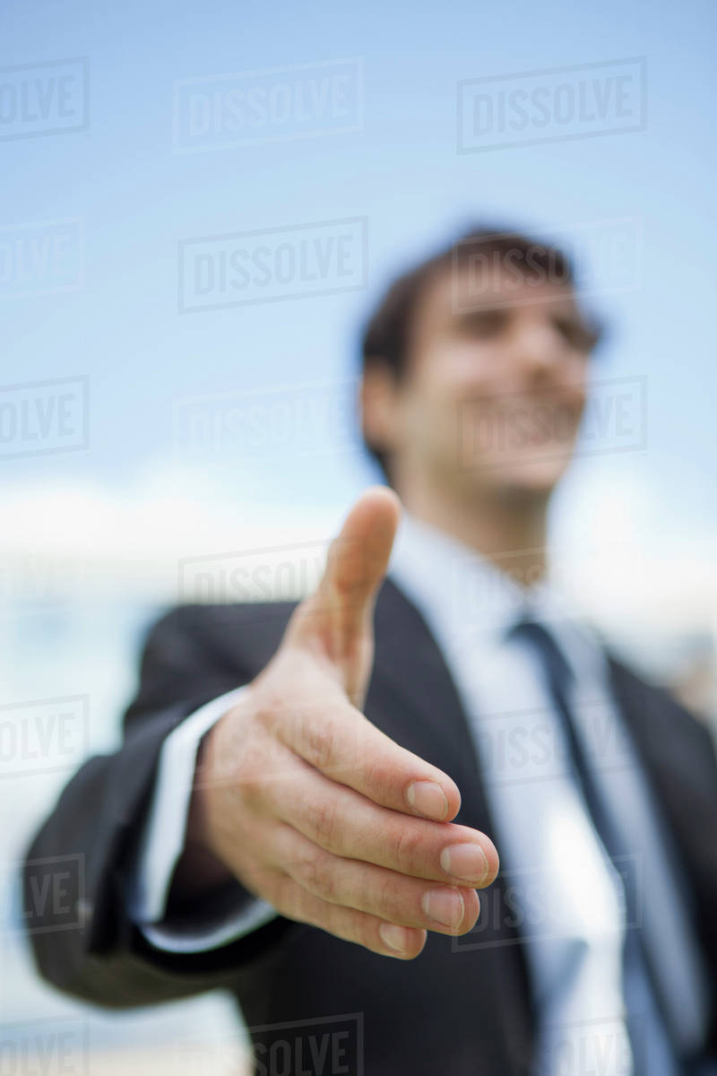Businessman extending hand for handshake, low angle view - Royalty-free ...