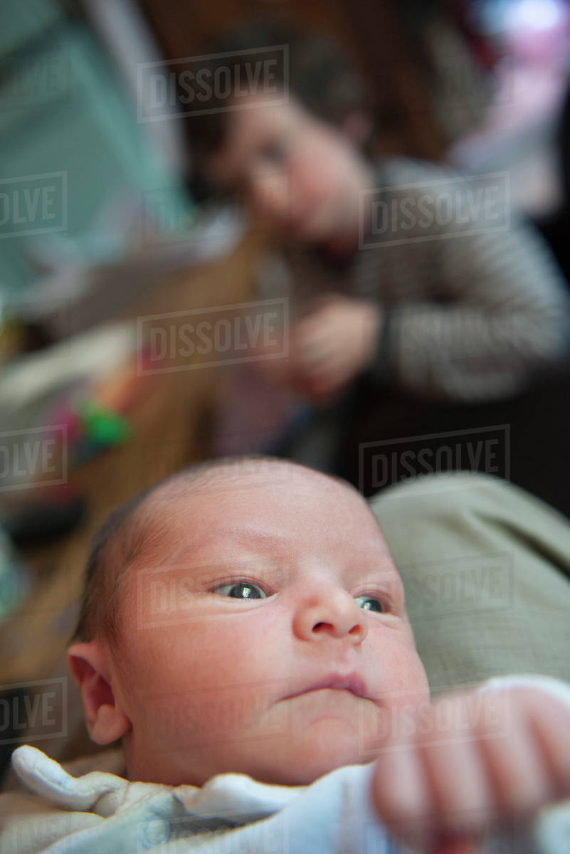Baby lying on back, looking away - Royalty-free Stock Photo | Dissolve