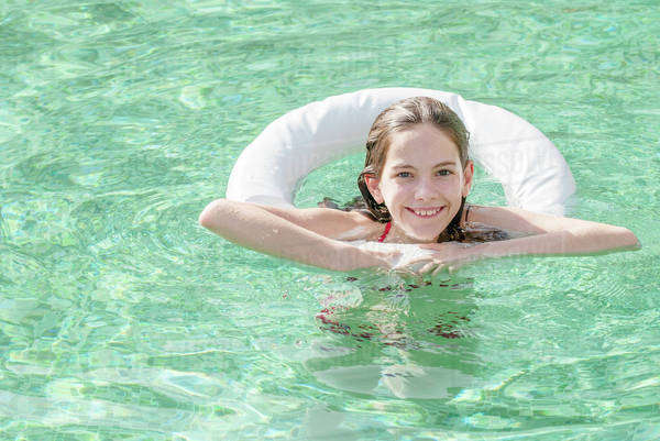 Girl floating in swimming pool, portrait - Royalty-free Stock Photo ...