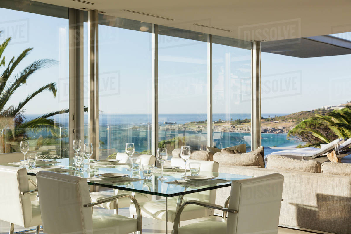Set table in modern dining room overlooking ocean - Royalty-free Stock ...