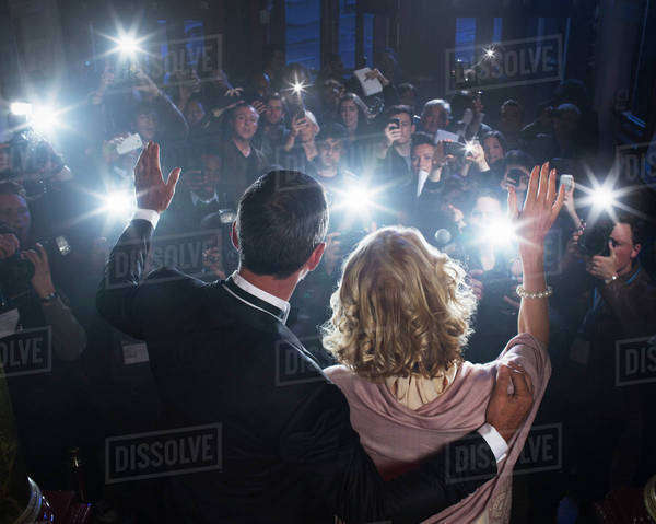 Celebrity couple waving to paparazzi at red carpet event - Royalty-free ...