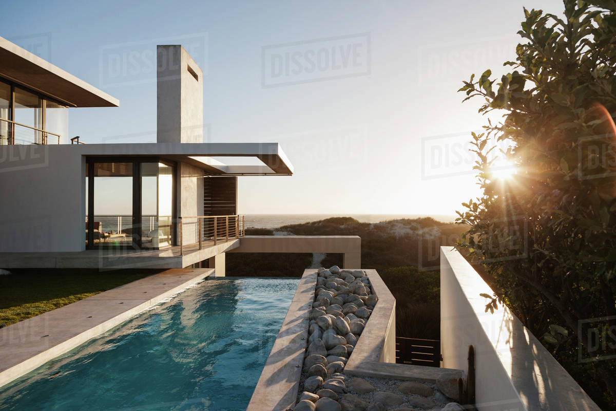 Modern house overlooking beach at sunset - Royalty-free Stock Photo ...