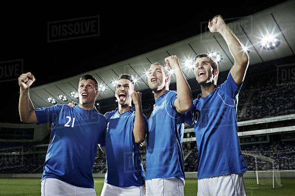 Soccer team cheering on field - Royalty-free Stock Photo | Dissolve