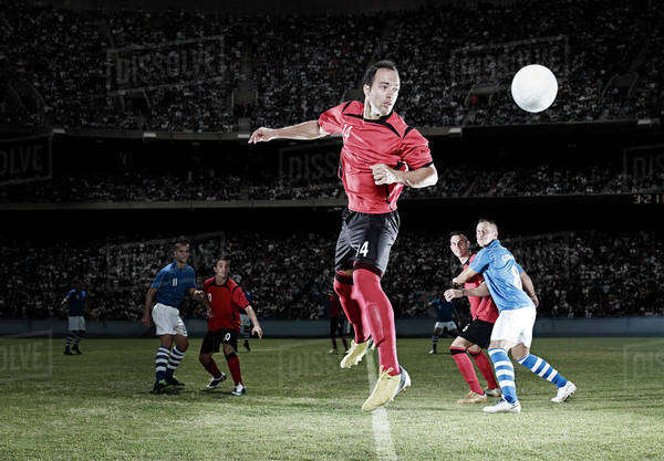 Soccer player jumping on field - Royalty-free Stock Photo | Dissolve